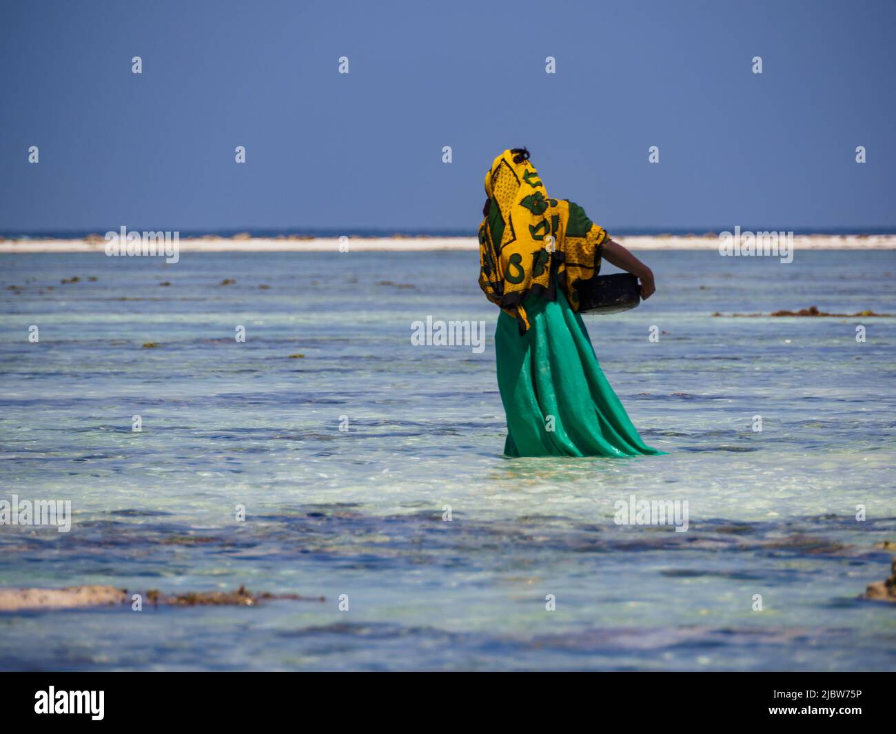 Matemwe, Zanzibar - January 2021: Woman in green dress and yellow ...