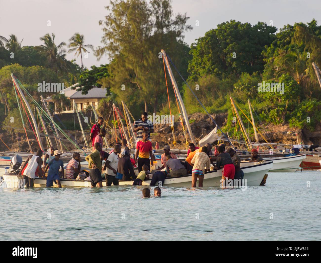 Zanzibar, Tanzania - Jan, 2021: Fishermen collecting fish from wooden ...