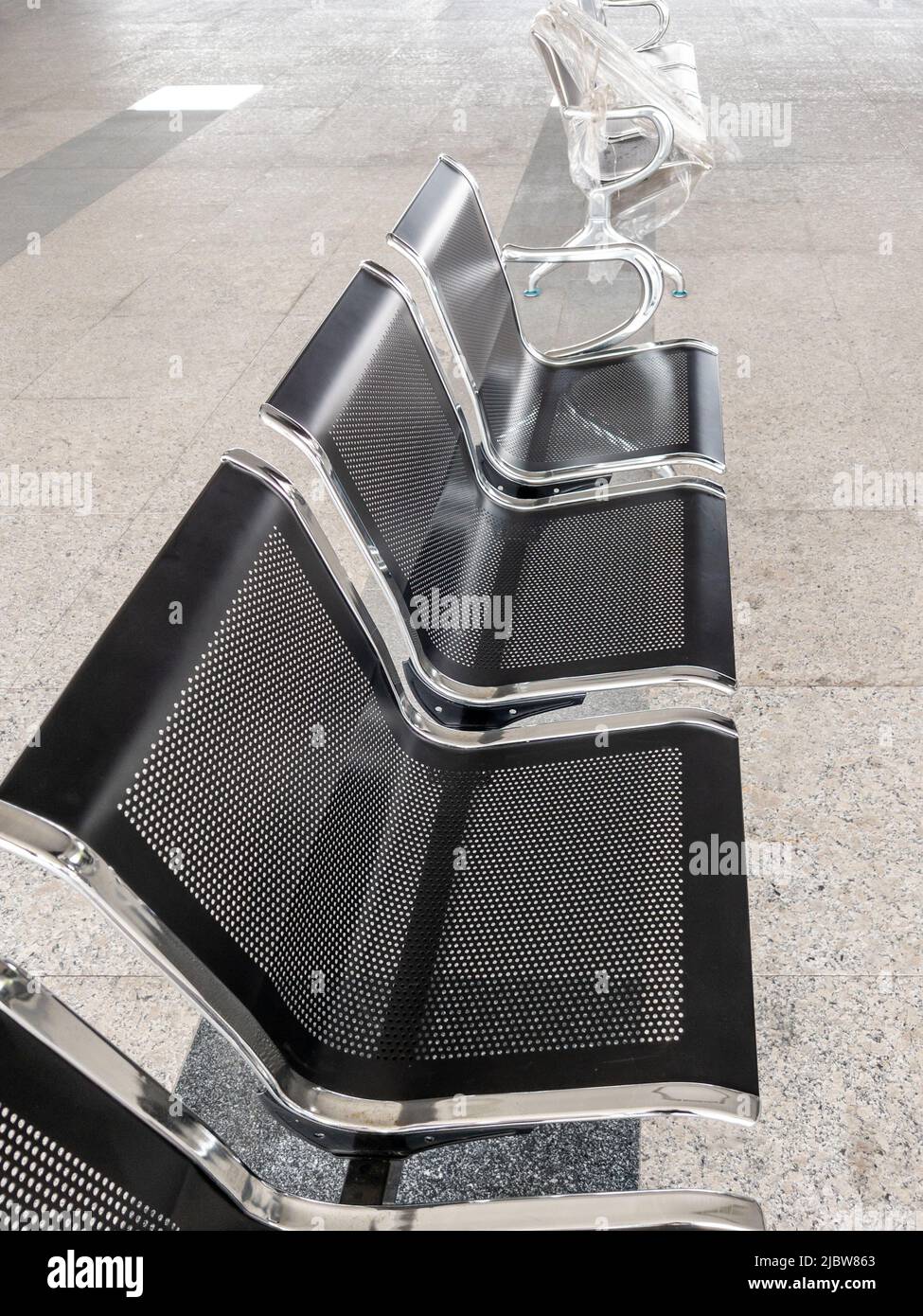 The new modern metal chair is in a row in front of the ticket booth of ...