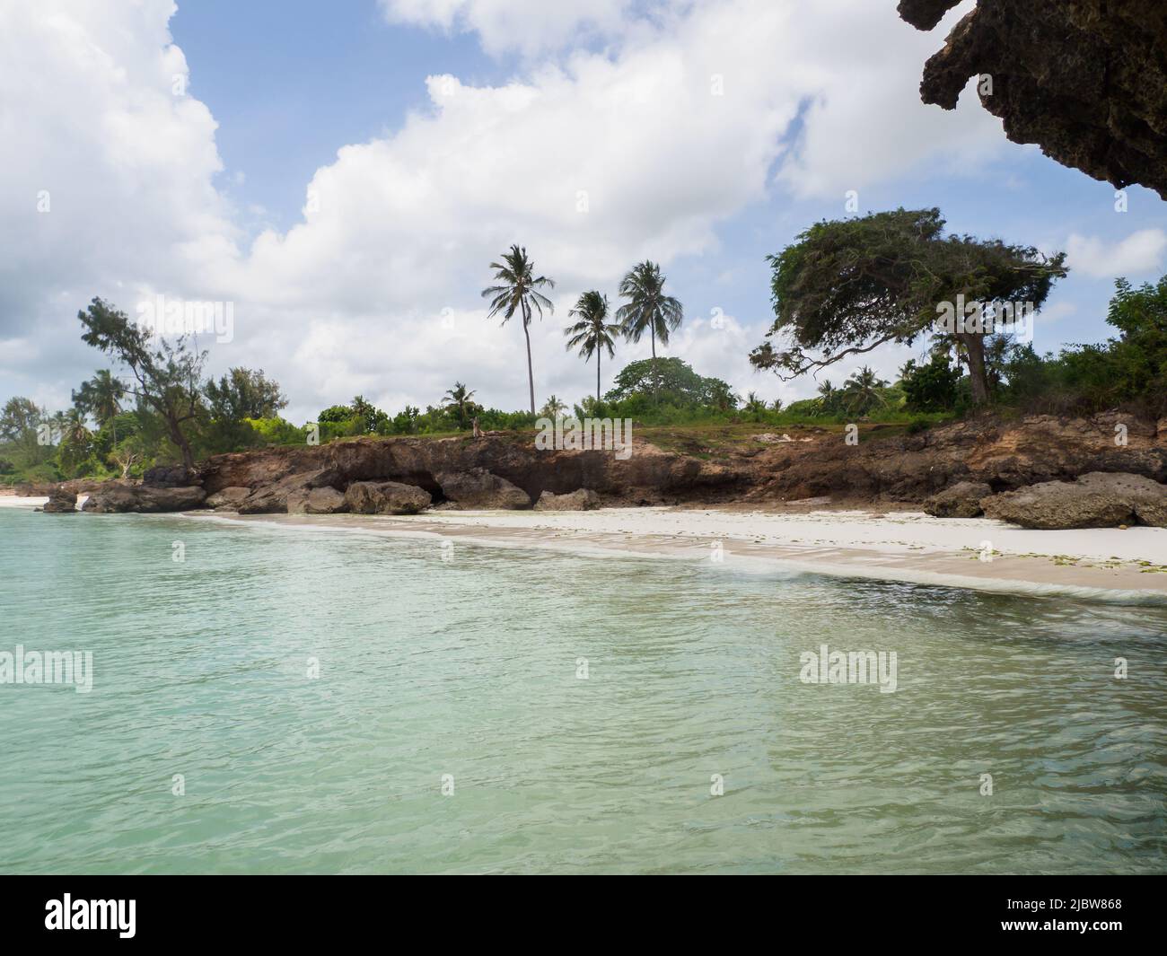 Palm trees on the cliff over the water of Indian ocean at the Menai Bay ...