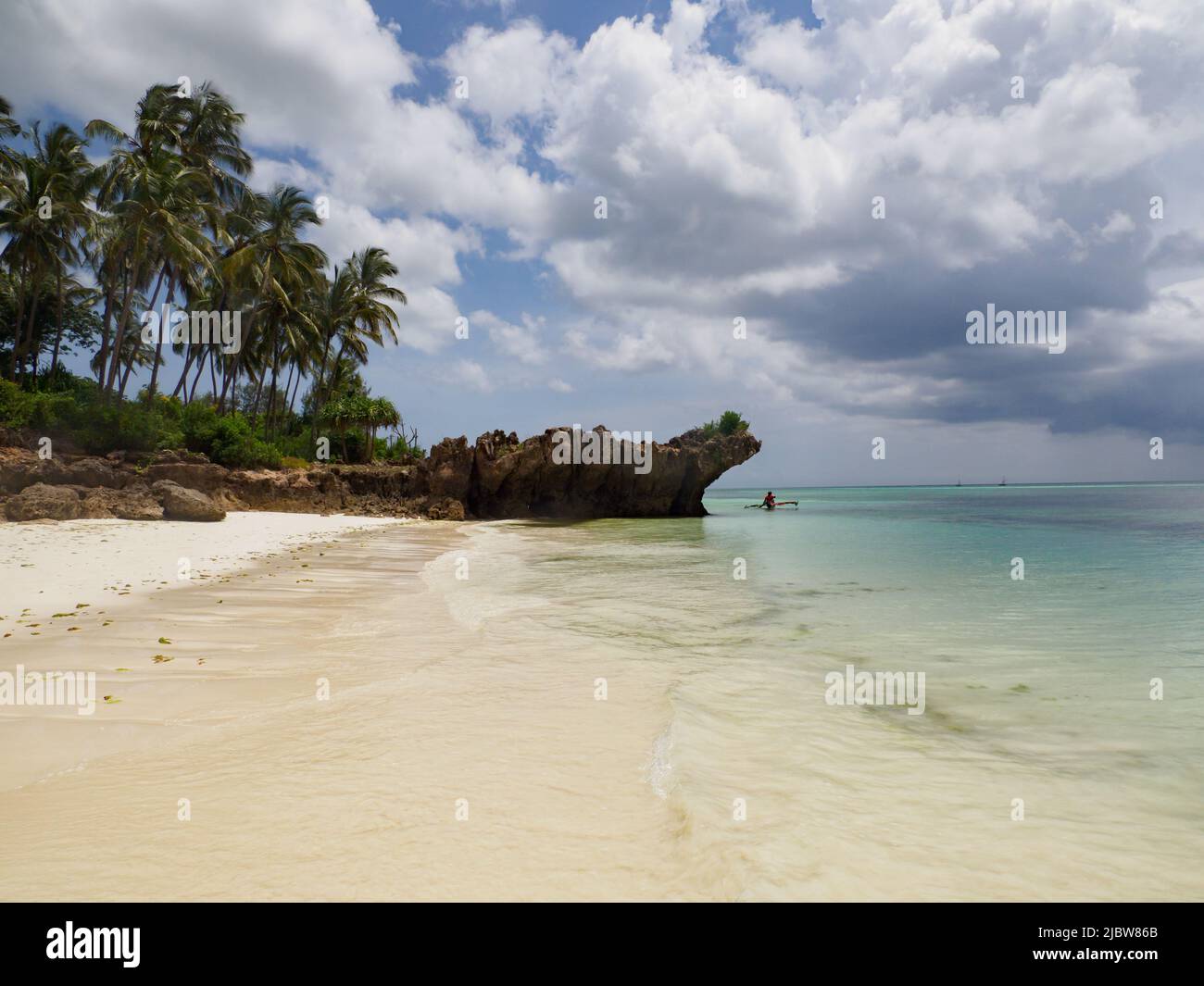 Palm trees on the cliff and hidden sandy beach over the water of Indian ...