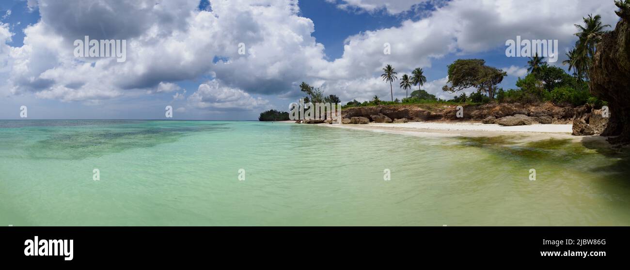 Palm trees on the cliff and hidden sandy beach over the water of Indian ...