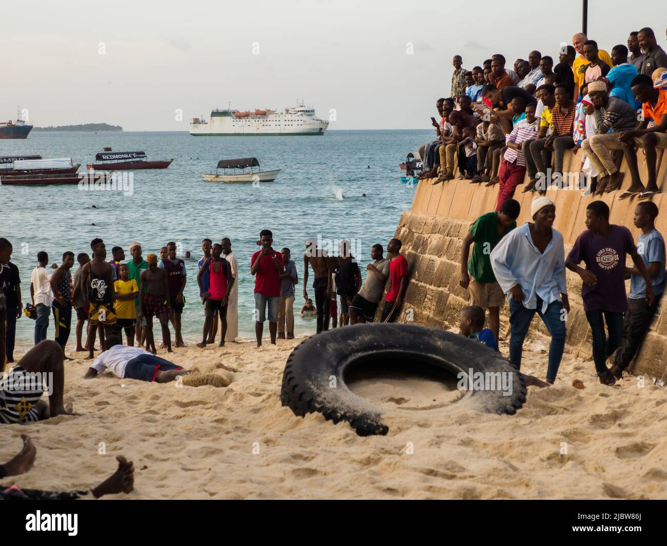 Stone Town, Zanzibar, Tanzania - January 2021: Crowds of people watch ...