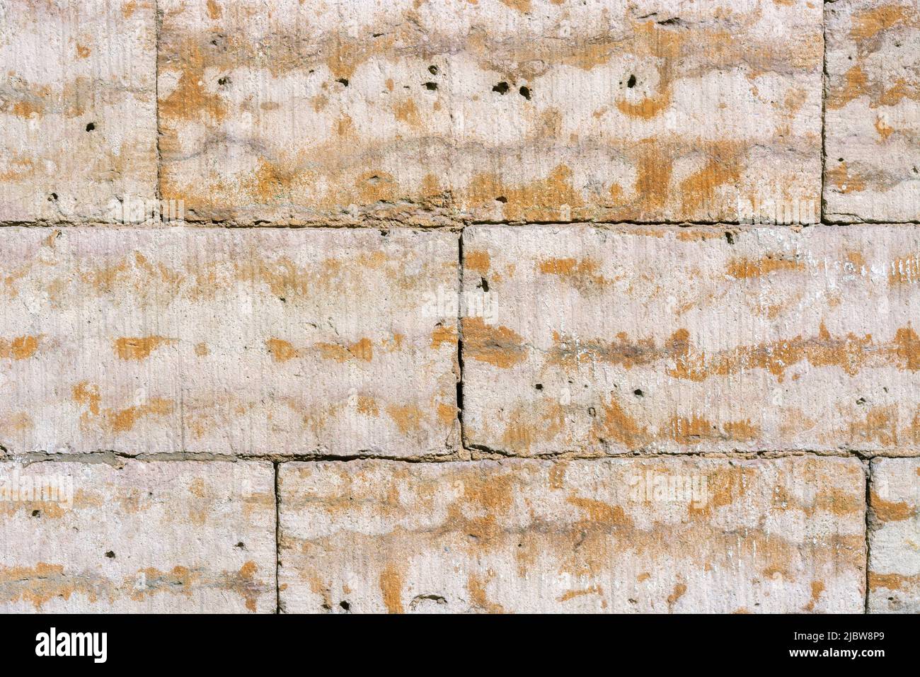 Wall of colorful stone blocks with red spots to use as a background ...