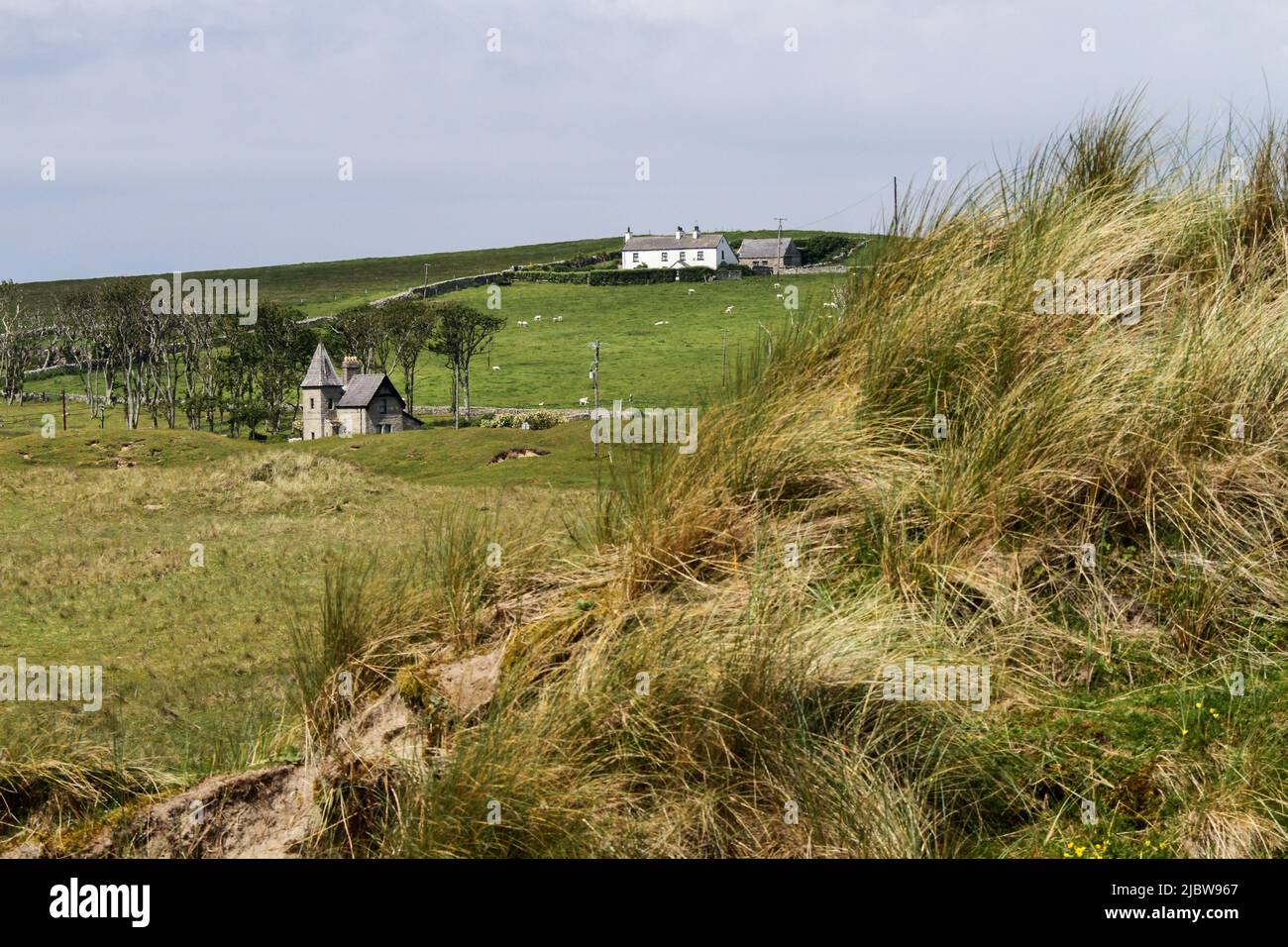 View of Classiebawn Castle gate lodge and Irish whitewashed cottage ...
