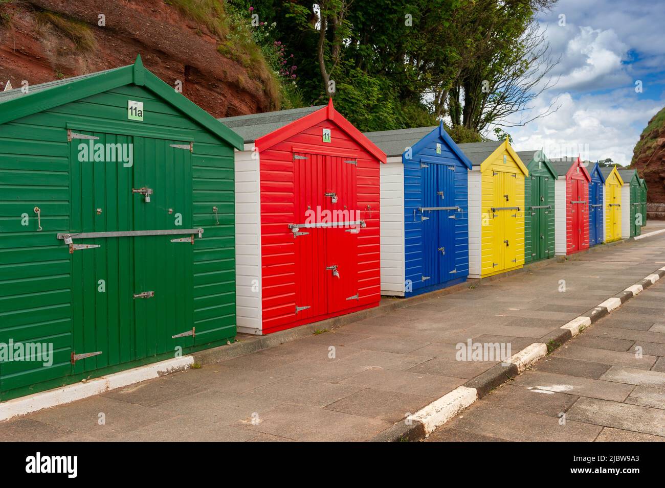 Brightly Coloured Beach Huts on the seafront at Coryton Cove, Dawlish ...