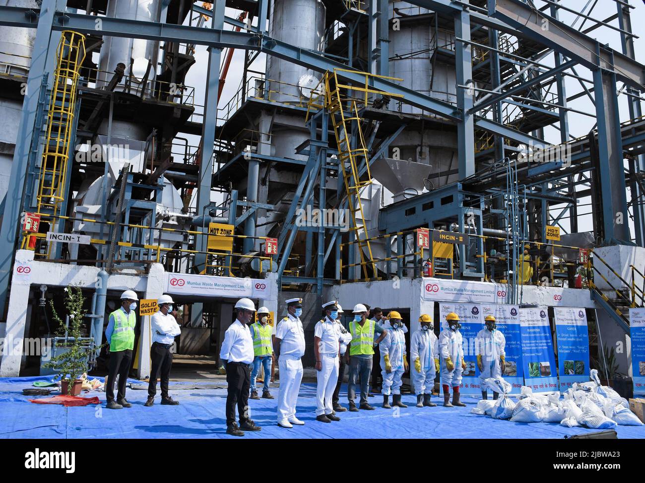 Custom officials and workers are seen standing near narcotic substance ...