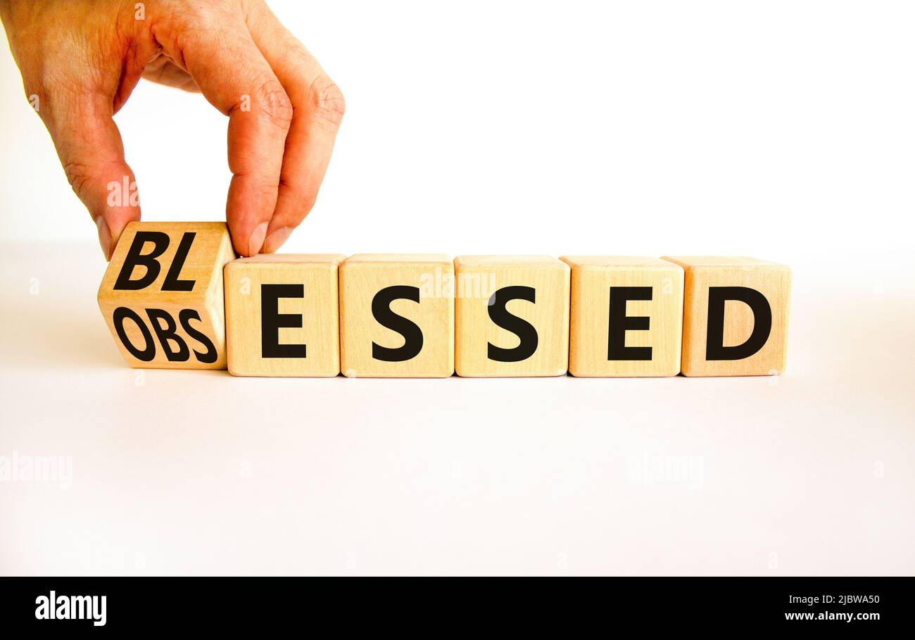 Blessed or obsessed symbol. Businessman turns wooden cubes and changes ...
