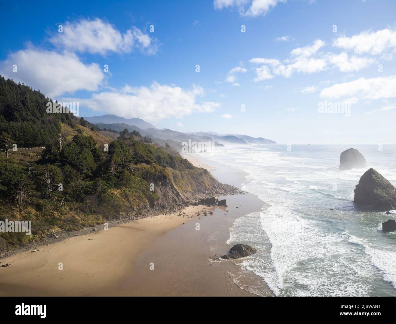 Beautiful picturesque seascape. Hilly green coast, sandy beach, clear ...