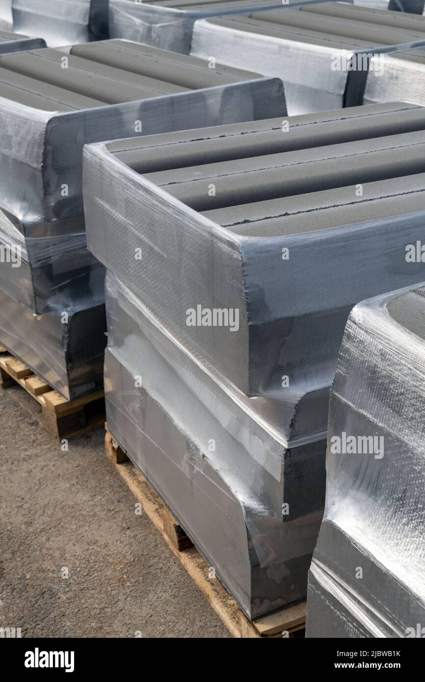 Gray curb stone in stack. Preparing to repair the road Stock Photo - Alamy