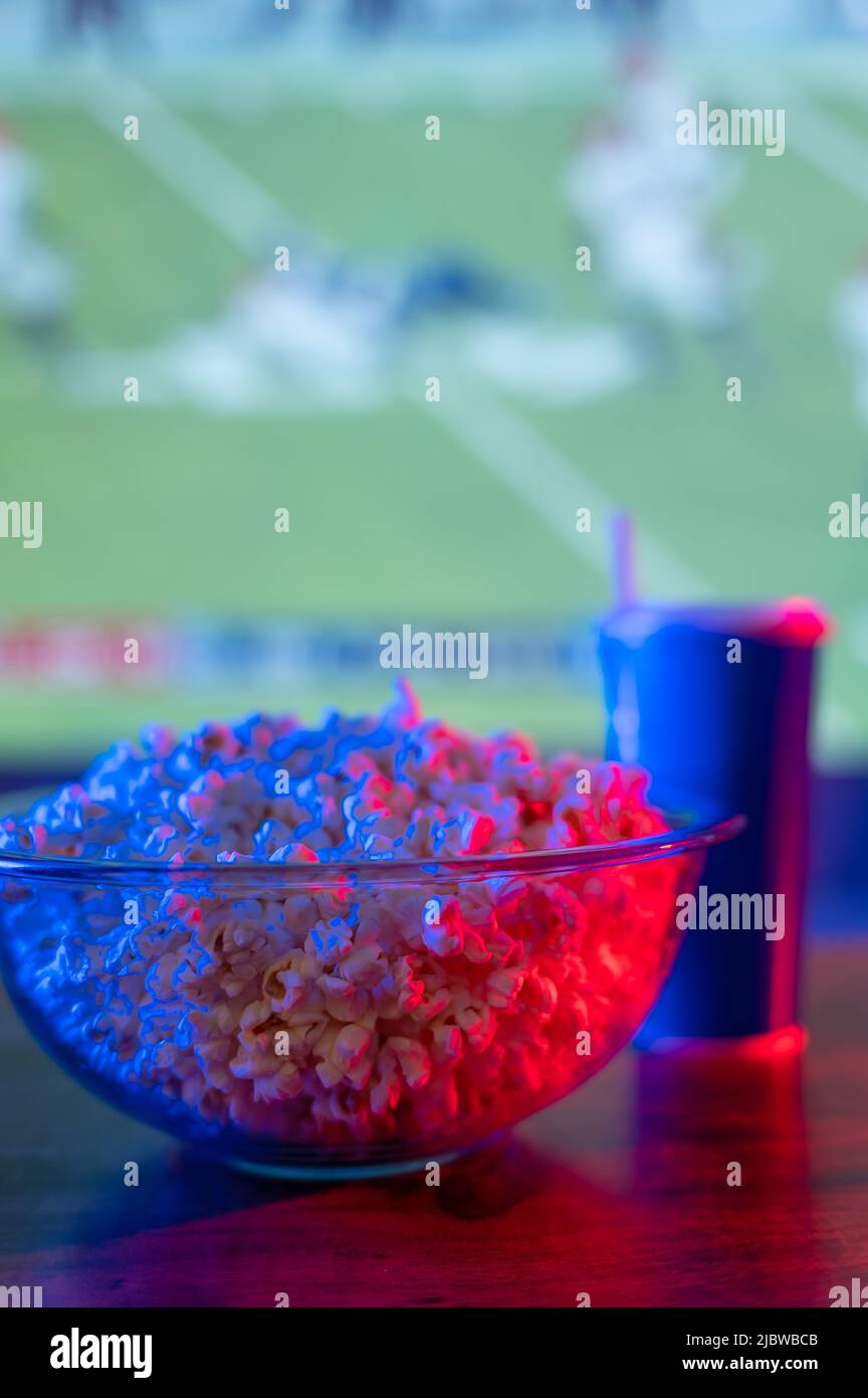 Rest in front of the TV. A large bowl of popcorn, a drink in a glass ...