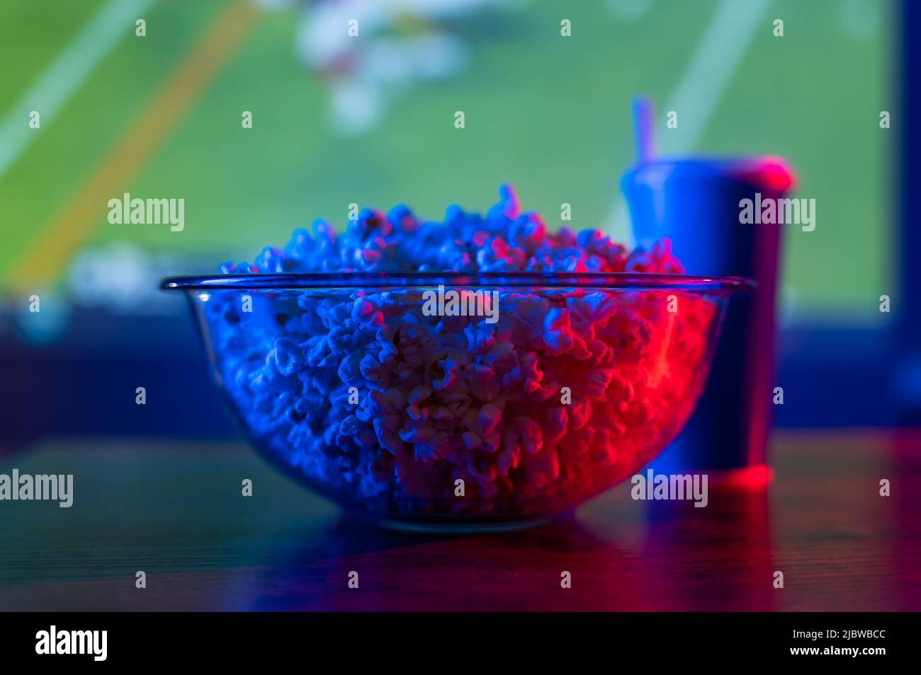 The traditional food of a sports fan is popcorn in a large glass bowl ...