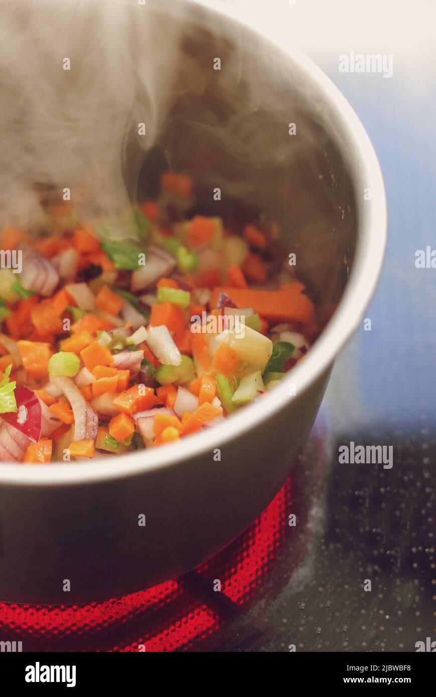 Chopped vegetables being cooked hi-res stock photography and images - Alamy
