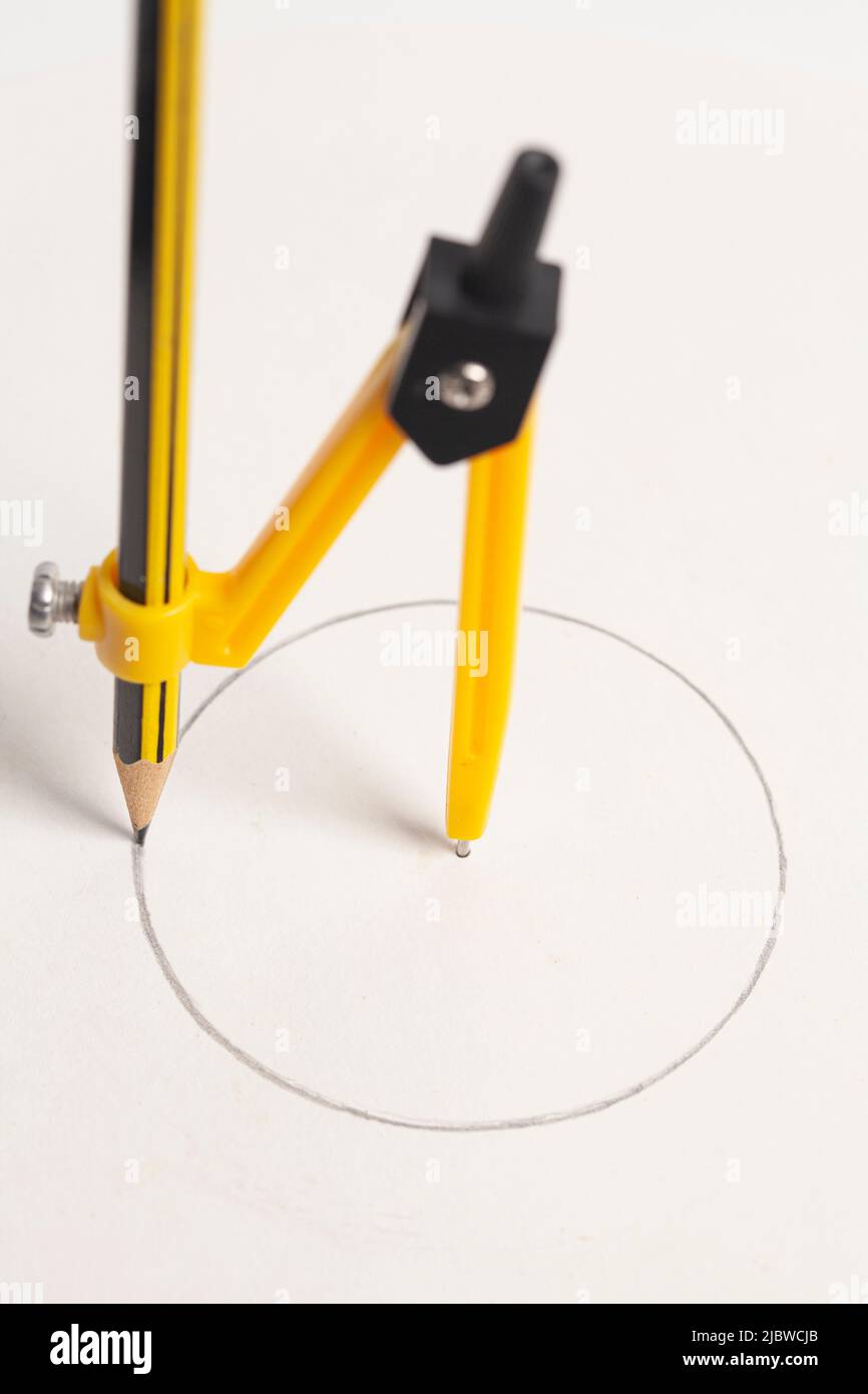 Yellow compass with pencil isolated on white background Stock Photo - Alamy
