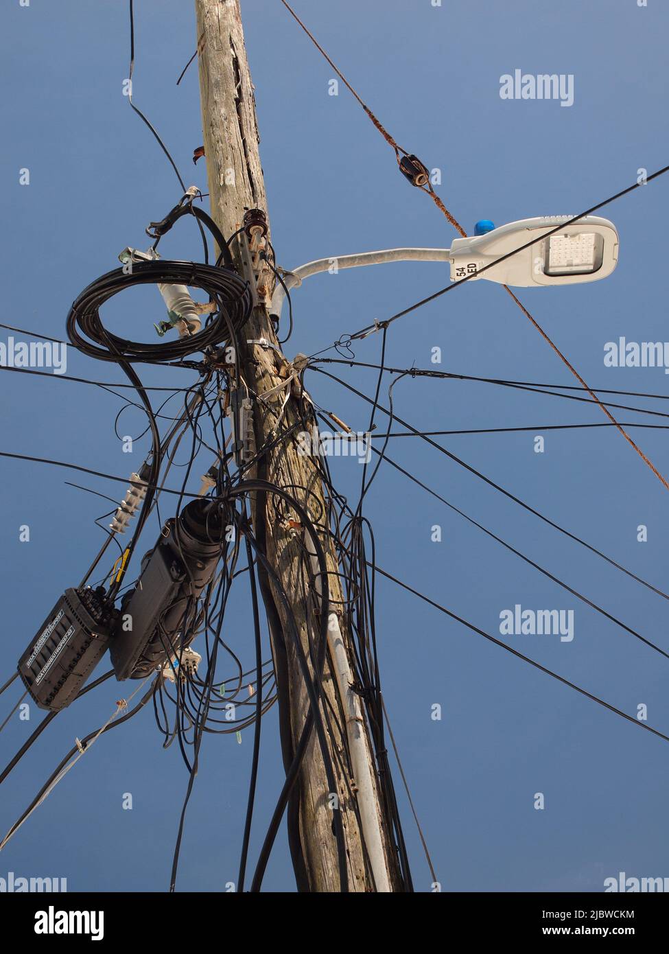 Tangle of wires on a utility pole in Bermuda. A scene duplicated around ...