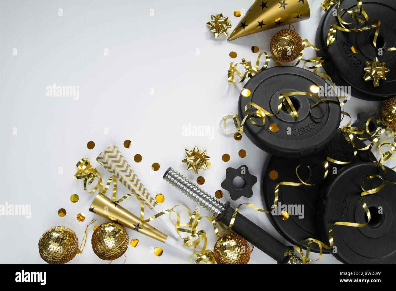 New Year's Eve gym composition with dumbbells, golden decorations and ...