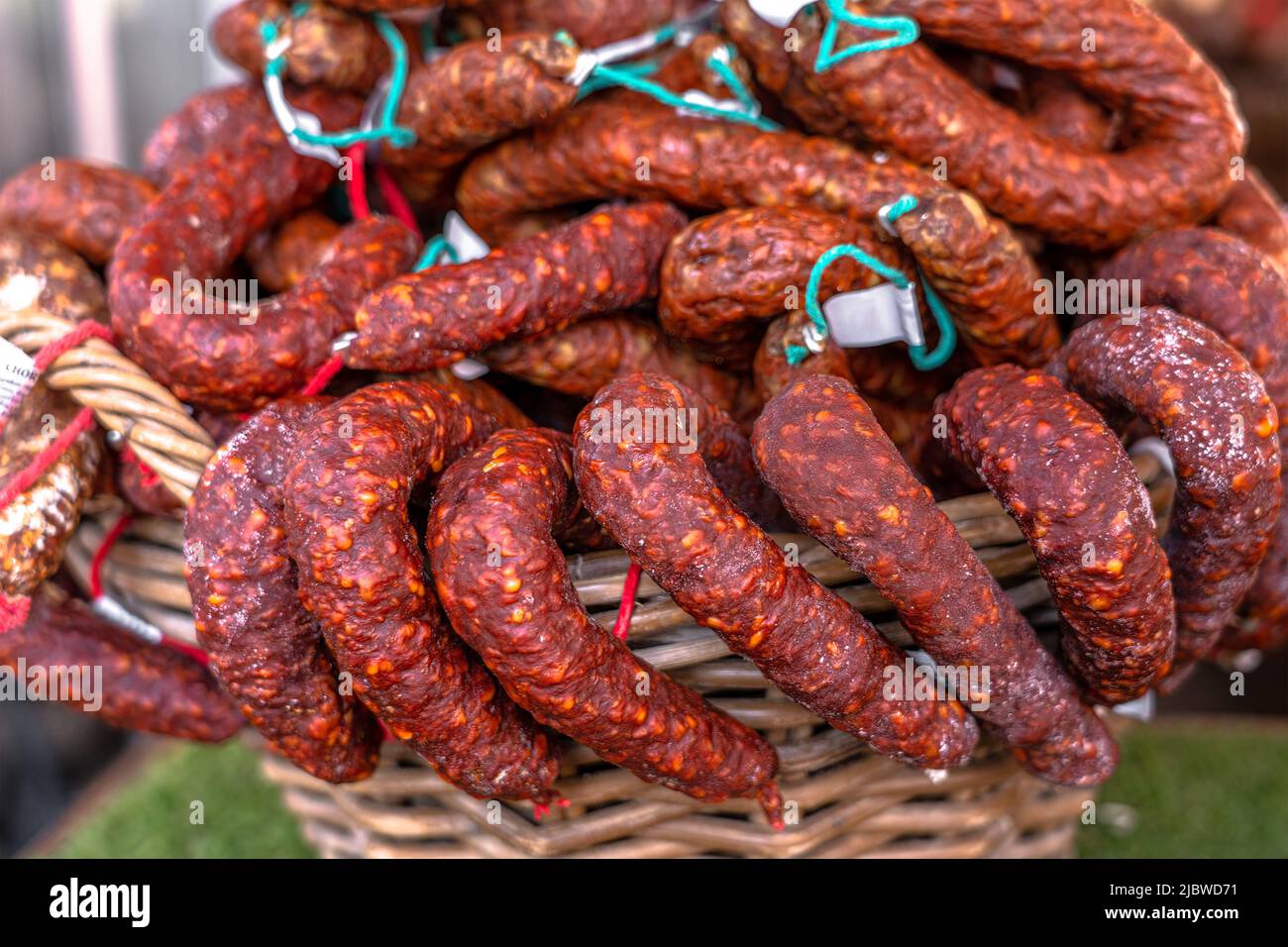 Stacks of dry-cured sausages - saucisson, typically made of pork, or a ...