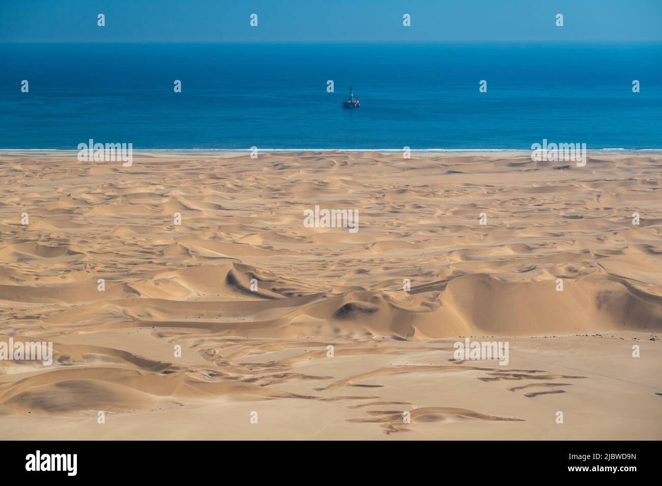Namib desert and Atlantic ocean shore, with oil rigs on the horizon ...