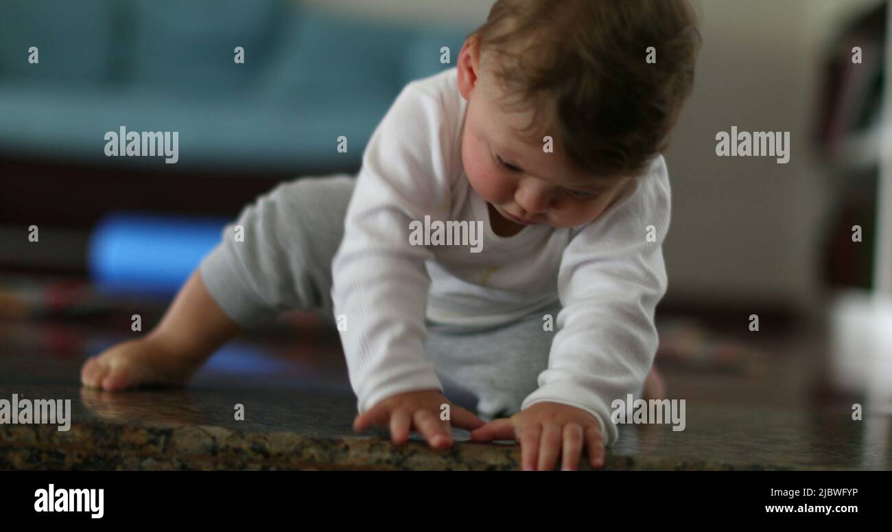 baby climbing down home step, infant development Stock Photo - Alamy