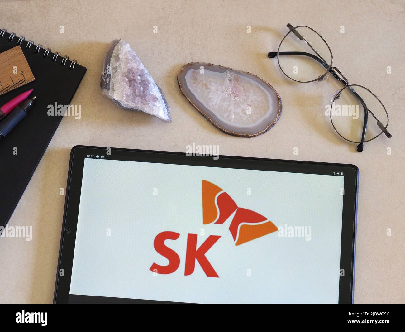 In this photo illustration, SK Group logo seen displayed on a tablet ...