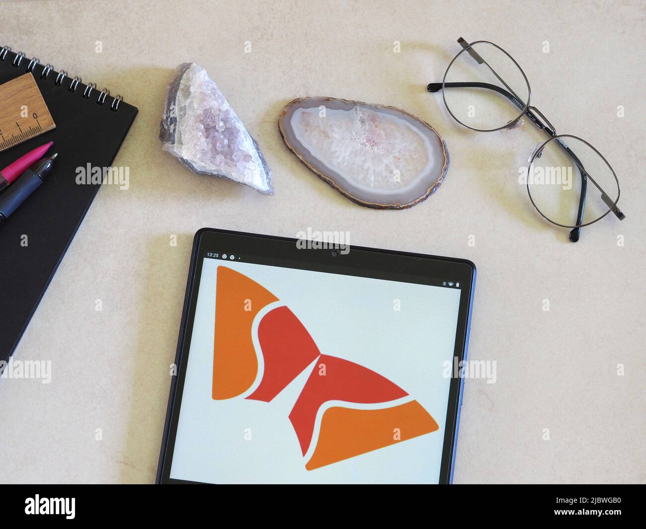 In this photo illustration, SK Group logo seen displayed on a tablet ...