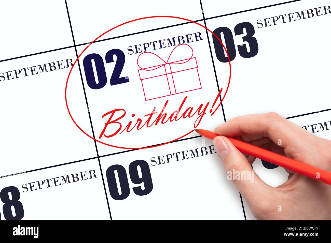 2nd day of September. The hand circles the date on the calendar 2 ...