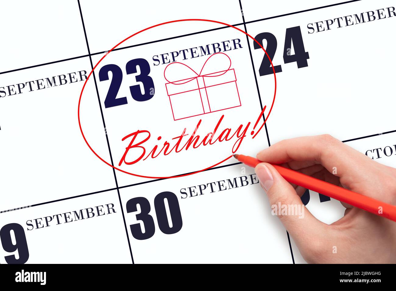 23rd day of September. The hand circles the date on the calendar 23 ...