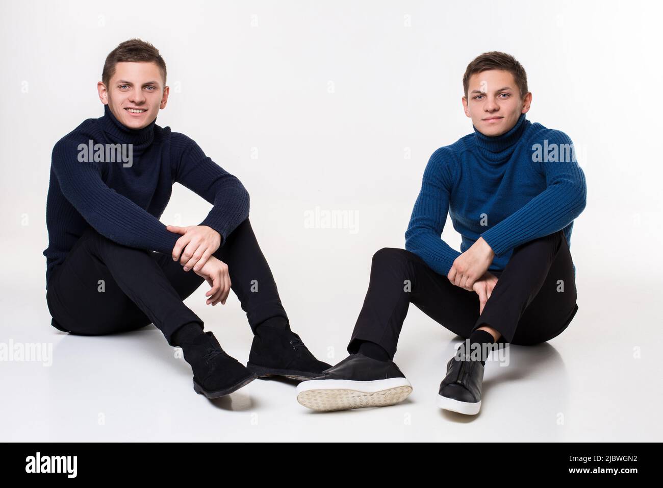 Casual twin brothers. Studio shoton a white background Stock Photo - Alamy