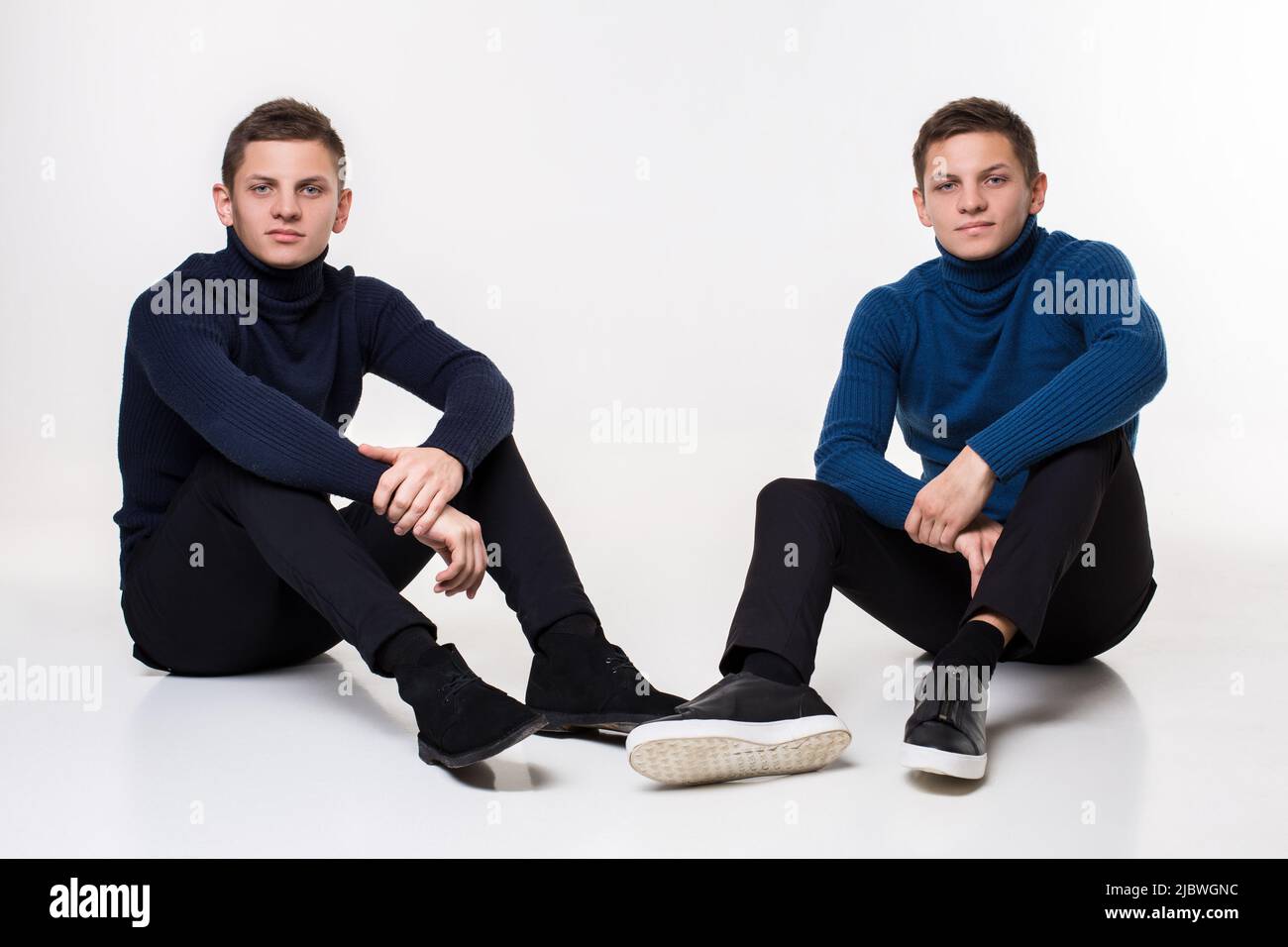 Casual twin brothers. Studio shoton a white background Stock Photo - Alamy