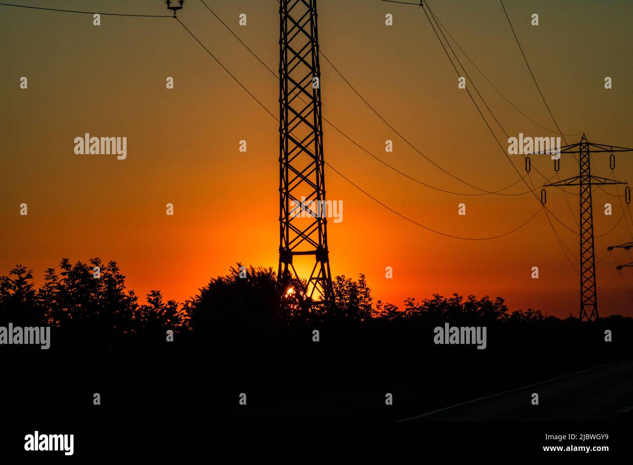 Electric power pylon, electric tower at sunset Stock Photo - Alamy