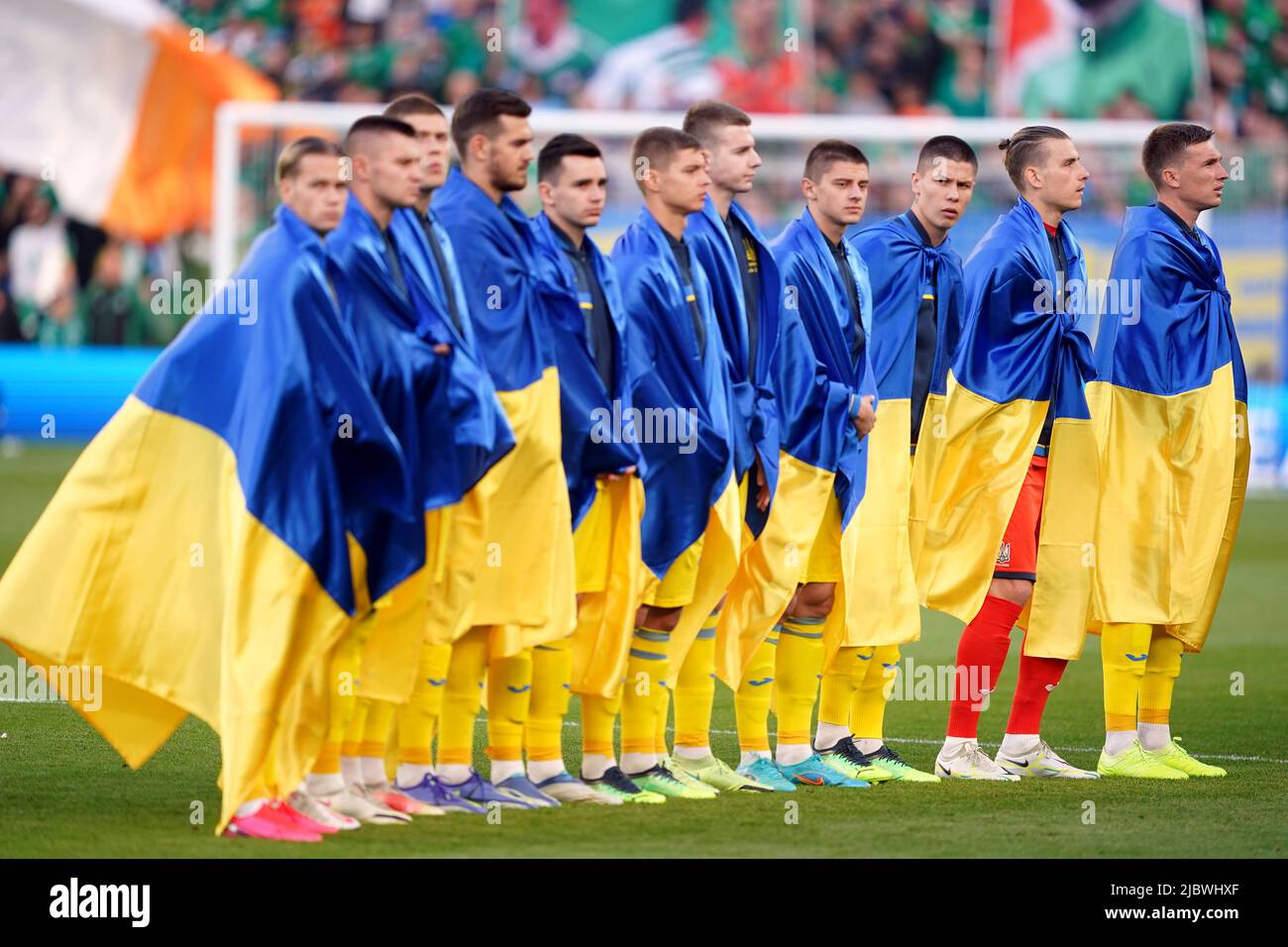 Ukraine players line up wrapped in their national flag before the UEFA ...