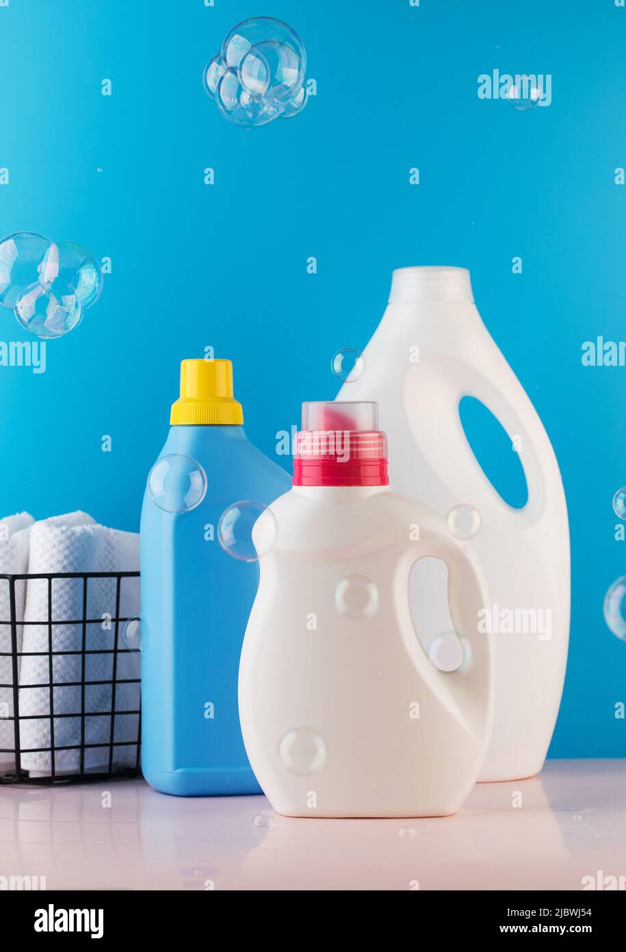 A set of bottles with gel for washing clothes with flying soap bubbles ...