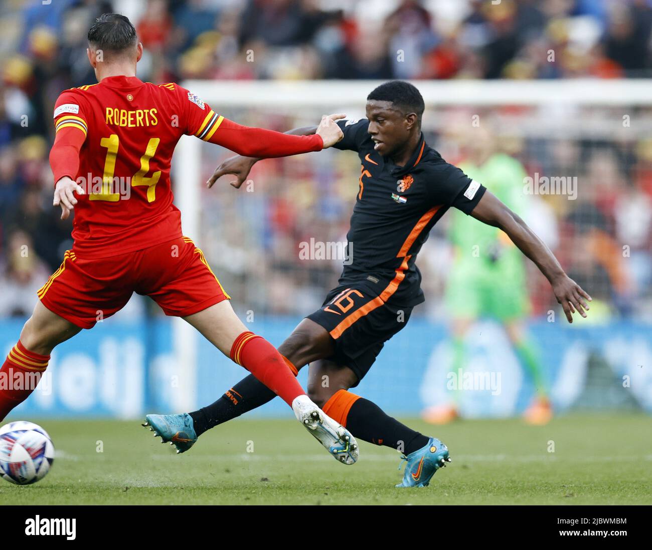 CARDIFF - (lr) Connor Roberts of Wales, Tyrell Malacia of Holland ...