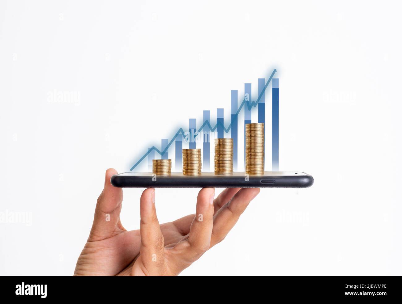 Close up photo of businessman holding smartphone with coin stacks and ...