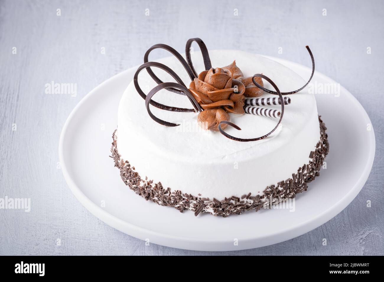 Cheesecake on a light table. The cake is decorated with chocolate Stock ...
