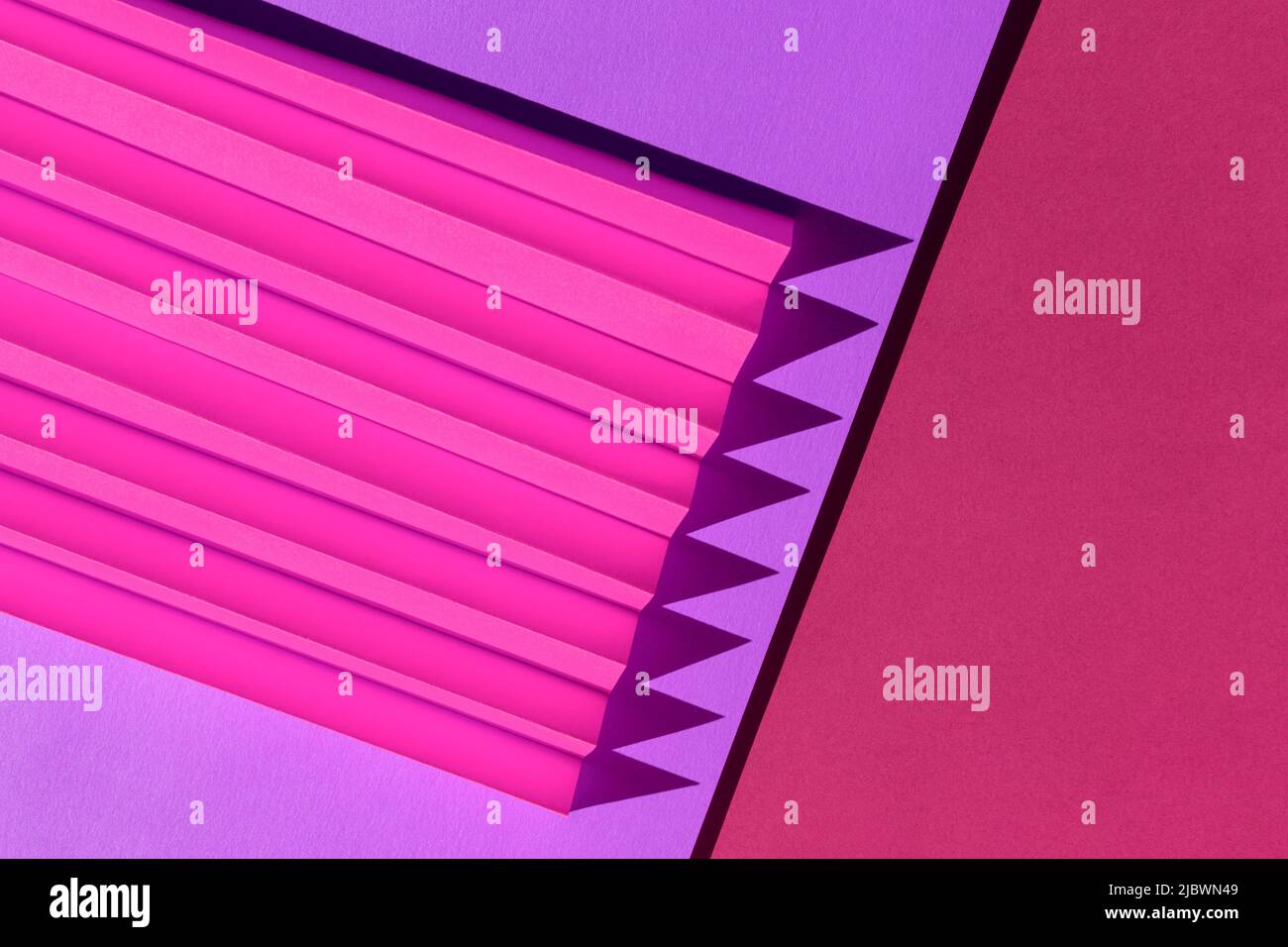 Abstract pink and purple colored paper texture. Folded paper with harsh ...