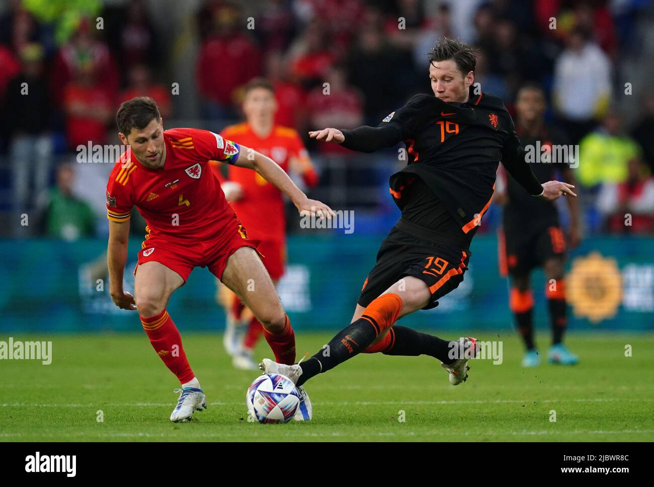 Wales' Ben Davies (left) and Netherlands' Wout Weghorst in action ...