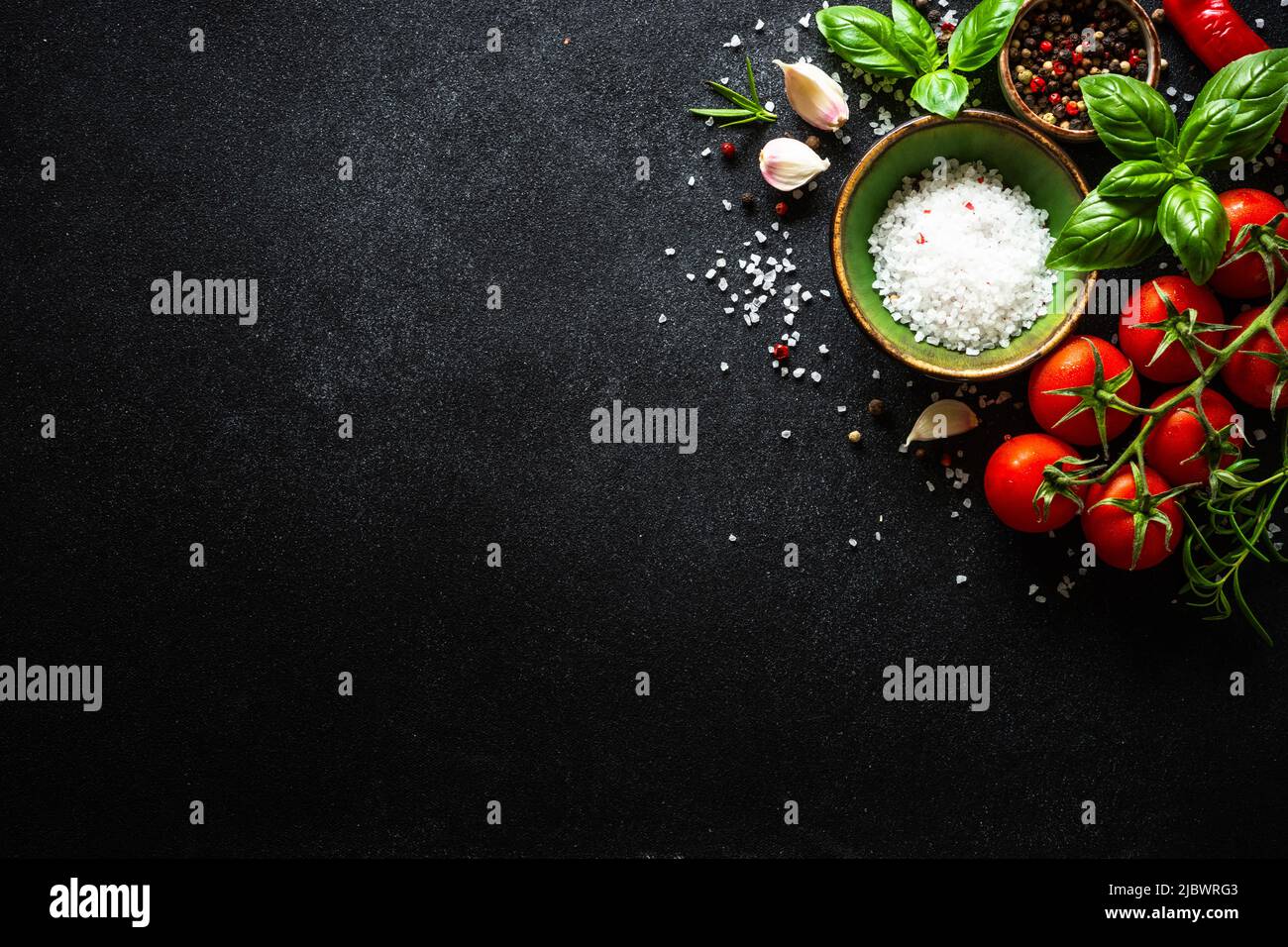 Food cooking background on black stone table Stock Photo - Alamy