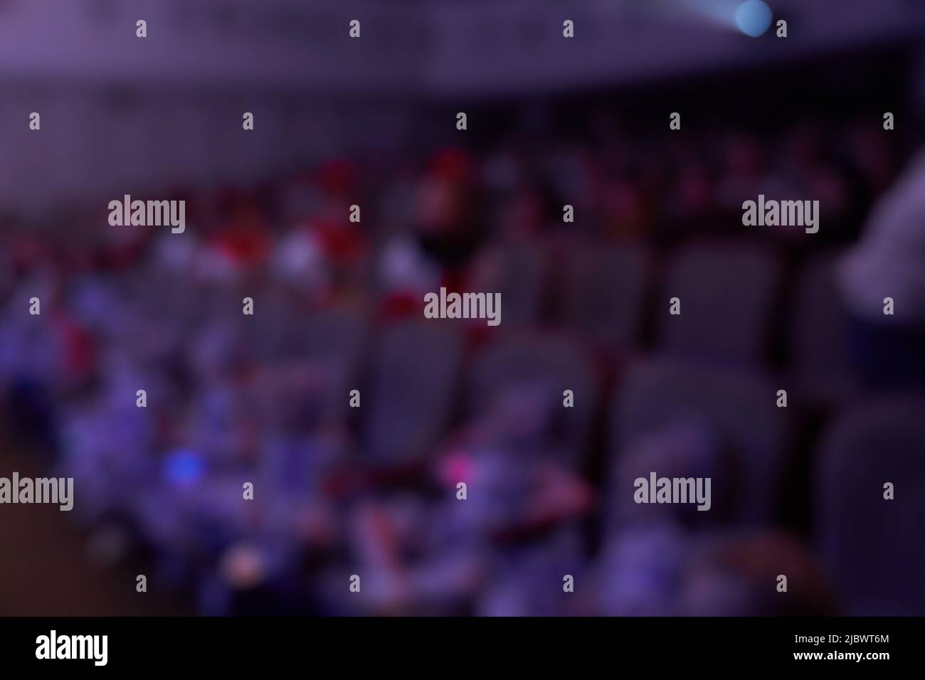 Event hall with chairs on a blurry background. The audience of a music ...