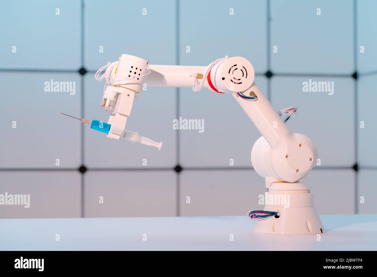 Robot hand with a medical syringe. Future medicine concept using robots ...