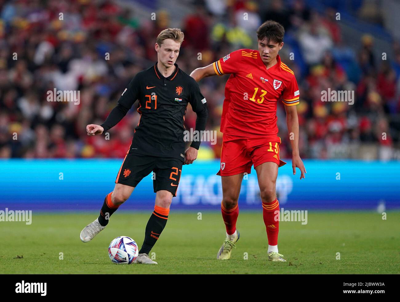 Netherlands' Frenkie de Jong (left) and Wales' Rubin Colwill battle for ...