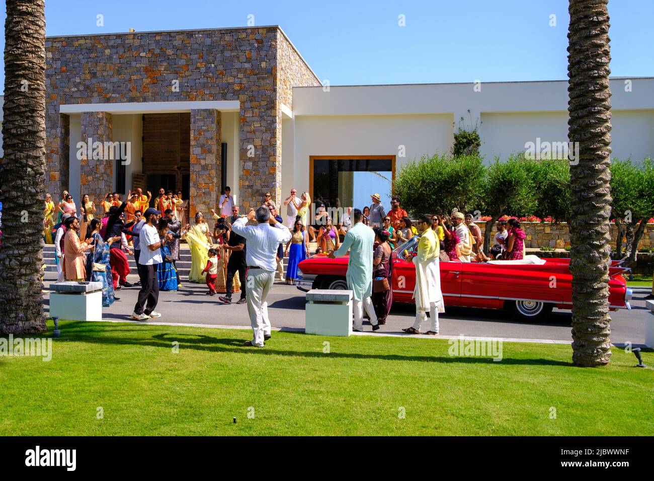 in front of the hotel there is a colorfully dressed indian wedding ...