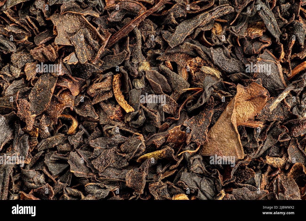 Brown flakes of black loose leaf tea - India variety. Dry leaves under ...
