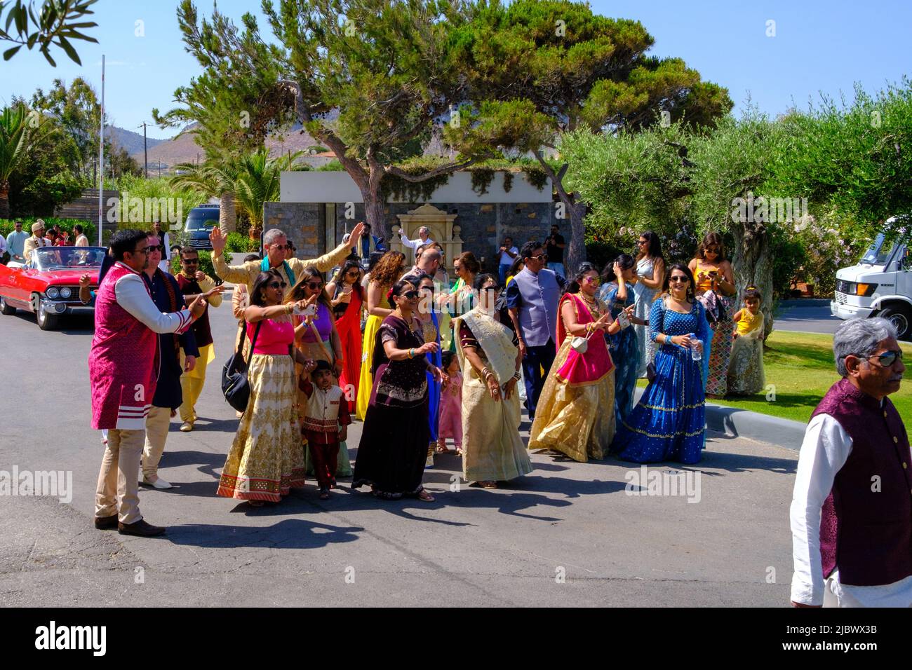 in front of the hotel there is a colorfully dressed indian wedding ...