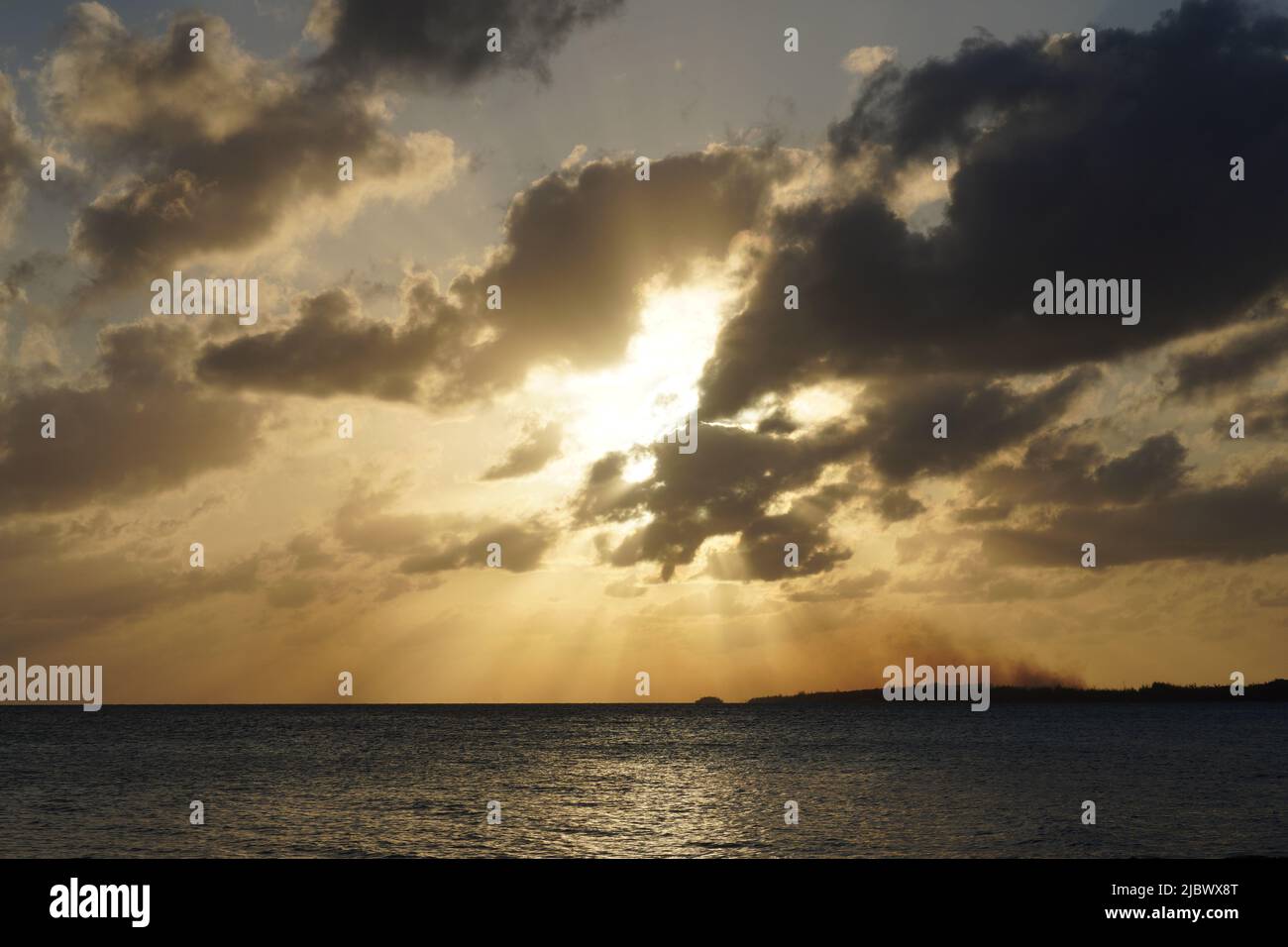 Bahama Sunset - A fire burns on the island below a beautiful sunset ...