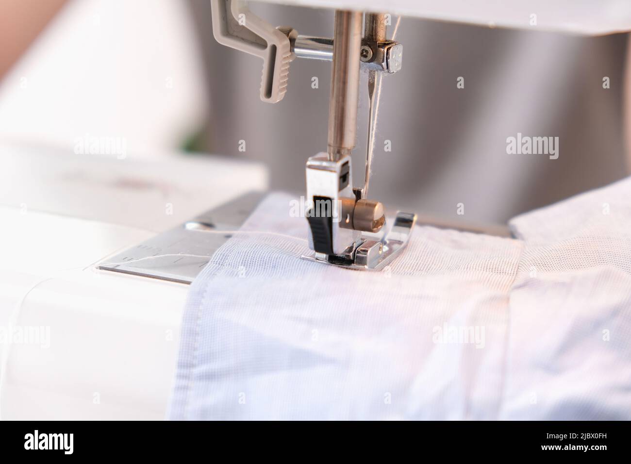 A man sews clothes on a sewing machine. Hobbies, needlework, creativity ...