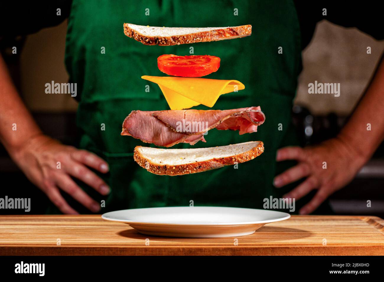 Sandwich falling deconstructed food at home kitchen with chef Stock ...