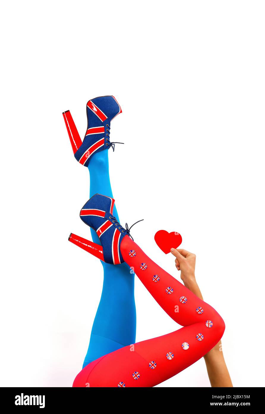 Female legs are stretched out high. They wear high heels with a British ...