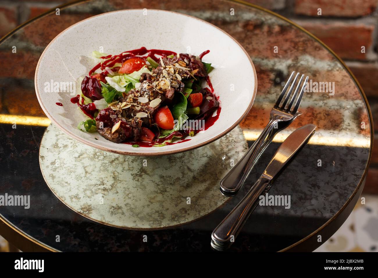 Salad with veal and tomatoes. Beef steak with raw vegetables mix side ...