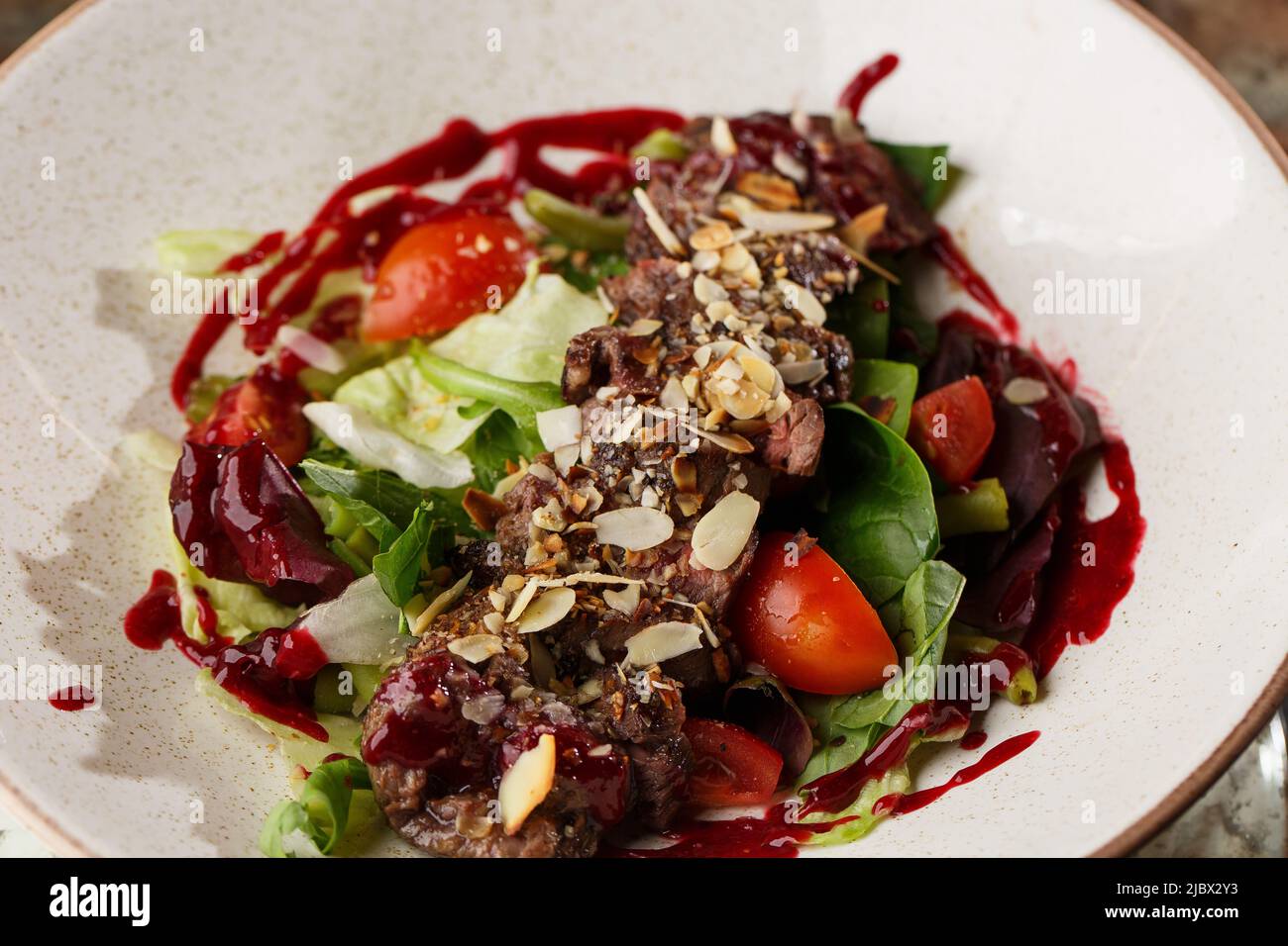 Salad with veal and tomatoes. Beef steak with raw vegetables mix side ...